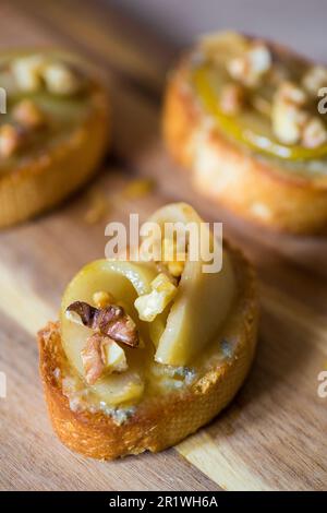 Sandwich or bruschetta with pear and blue cheese on white plate on ...