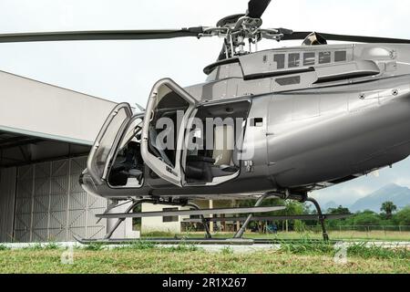 New helicopter with open cabin doors on helipad outdoors Stock Photo ...