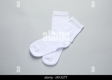 White socks on light grey background, flat lay. Space for text Stock ...