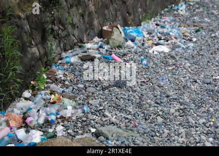Garbage scattered on pebbles outdoors. Recycling problem Stock Photo ...