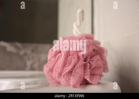 Pink shower puff on washbasin in bathroom Stock Photo - Alamy