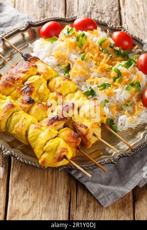 Joojeh kabab is a classic Persian chicken kebob with rice closeup on ...