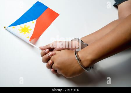 Human hand in handcuff with Philippines national flag on white ...