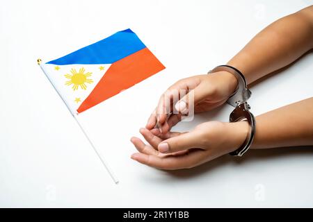 Human hand in handcuff with Philippines national flag on white ...