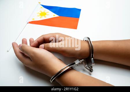 Human hand in handcuff with Philippines national flag on white ...