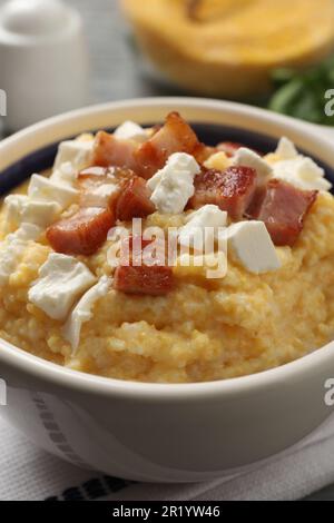 Delicious traditional Ukrainian banosh in bowl on grey wooden table ...