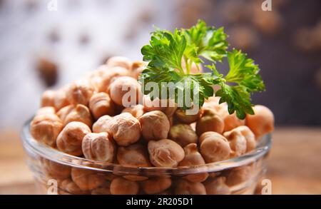 Composition with bowl of chickpeas on wooden table Stock Photo - Alamy