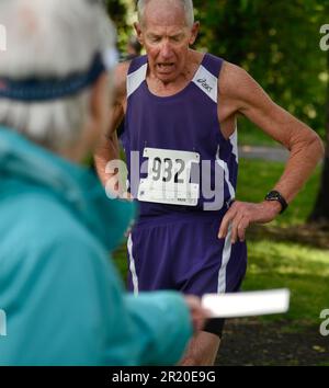 Participants cross the finish line after completing a 5K race in ...