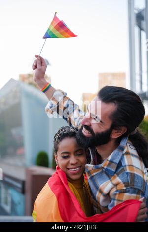 Two young people fighting for lgtbi pride with the flags. Concept ...