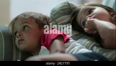 Children faces hypnotized by screen watching cartoons at night before ...