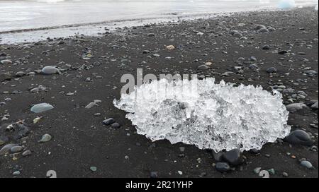 The chunks of melting ice on the ground, illuminated by sunlight Stock ...