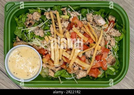 To go order of Caesar salad is made fresh in plastic container with ...