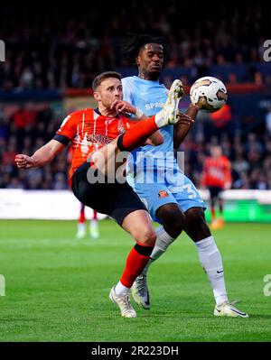 Luton Town's Jordan Clark (left) and Derby County's Ebou Adams battle ...