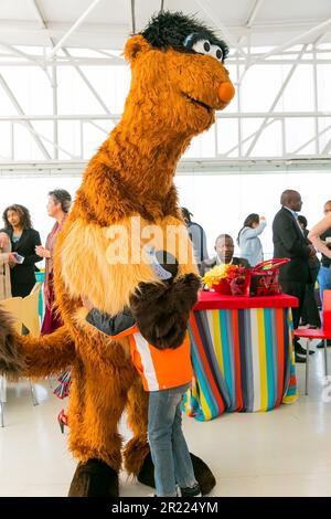 A large Sesame Street style character performing for African children ...