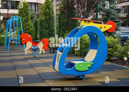 Empty spring rider on children's playground in residential area Stock ...