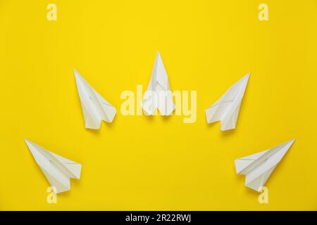 Paper planes on yellow background Stock Photo - Alamy