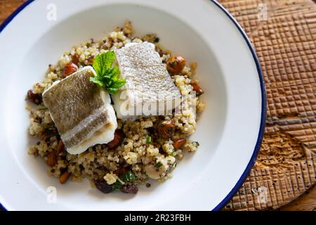 Baked cod with vegetables, nuts and quinoa Stock Photo - Alamy