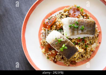 Baked cod with vegetables, nuts and quinoa Stock Photo - Alamy