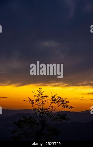 Colorful magnificent sunset in countryside above hills and fields ...