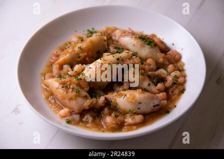 Baby Squid stew with potatoes and prawns Stock Photo - Alamy