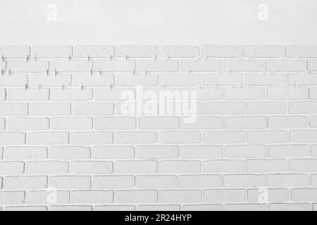Decorative white bricks with tile leveling system on wall Stock Photo ...