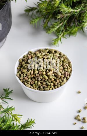 A pile of dried and fresh thyme Thymus vulgaris rests on a circular ...