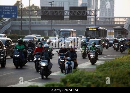 Jakarta, Indonesia-May 14, 2023: Busy traffic with chaotic vehicles scrambling on the highway ...
