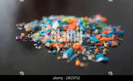 Close-up on many microplastic particles in human hand. Concept of ...