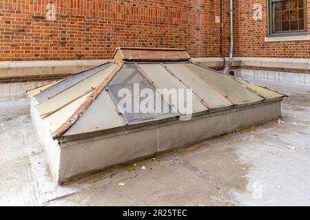 Old, vintage metal framed double pitched skylight on a flat commercial ...
