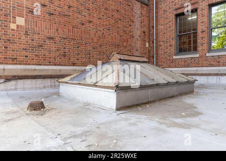 Old, vintage metal framed double pitched skylight on a flat commercial ...