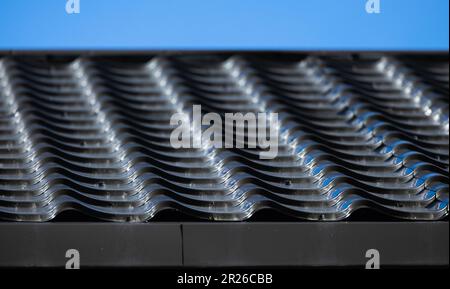 Metal roof tiling with wavy shape pattern, close up photo of modern ...