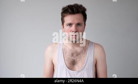 The angry European young man wearily looks. He is without strength and ...