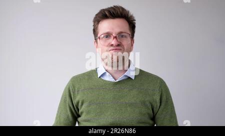 The angry European young man wearily looks. He is without strength and ...