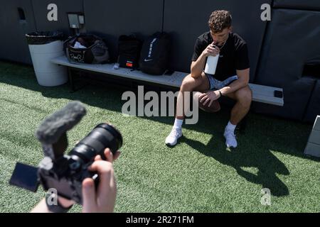 Adam Botkin, a football TikTok influencer, uses his phone while ...