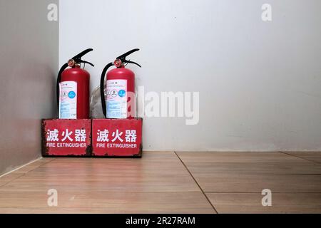 Two dry chemical fire extinguishers on the floor in a hotel building in ...