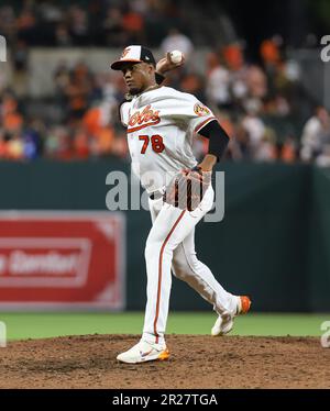 Baltimore Orioles pitcher Yennier Cano, second from left, hands the ...