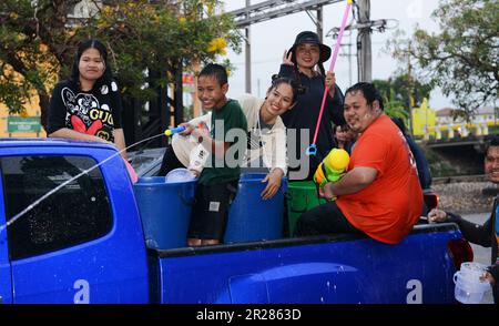 Local Thai people celebrating Songkran by splashing water from the back ...