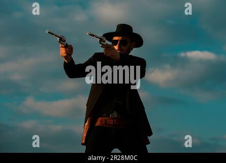 Cowboy shooting. Sheriff officer in black suit and cowboy hat. Man with ...