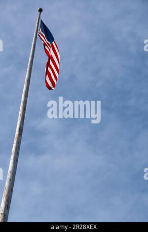 A low angle shot of a waving American flag in a cloudy sky Stock Photo ...