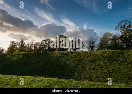 Trees behind a Neolithic earthwork at Avebury, Wiltshire Stock Photo ...