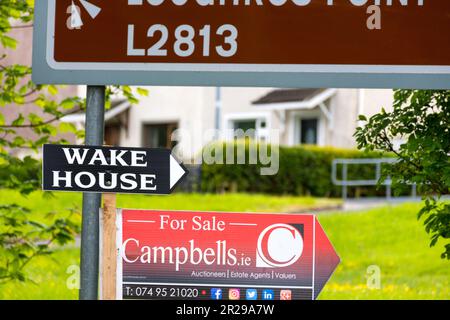 Wake House sign amongst other road signage in Ardara, County Donegal ...