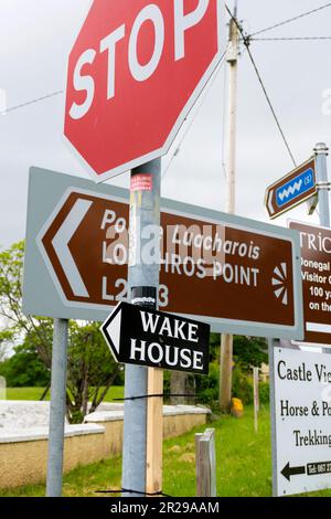 Wake House sign amongst other road signage in Ardara, County Donegal ...
