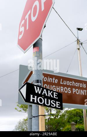 Wake House sign amongst other road signage in Ardara, County Donegal ...