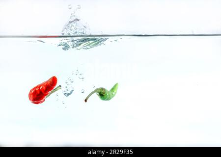 Red chilli, water splashes, solated on a white background Stock Photo ...