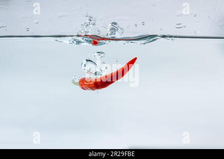 chilli drop water splashes Stock Photo - Alamy