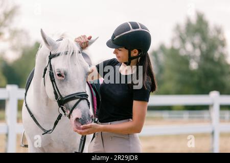 Female rider hand gently caressing beautiful thick red horse mane ...