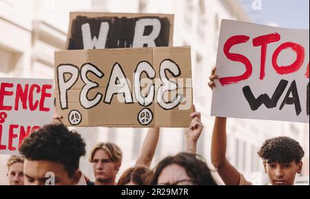 Strike for peace. Group of multicultural teenage activists chanting ...