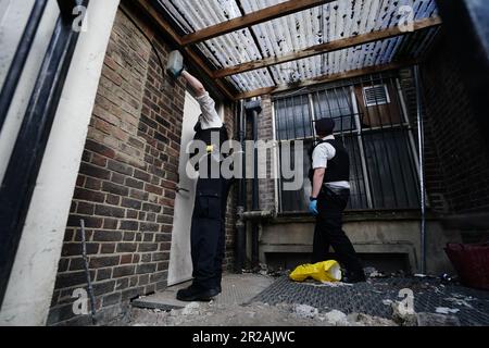 Police officers performing a weapons sweep as part of operational ...