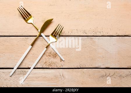 Golden forks and knife with colored handles on white background Stock ...