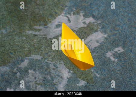 Beautiful yellow paper boat on water outdoors, space for text Stock ...